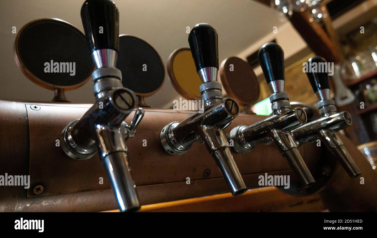 The beer taps in a pub Stock Photo - Alamy