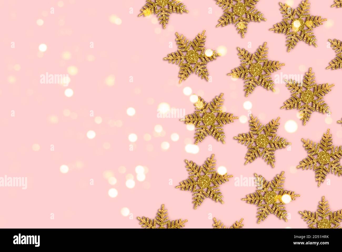 Frame made of golden snowflakes on a pink background. Christmas shiny ...