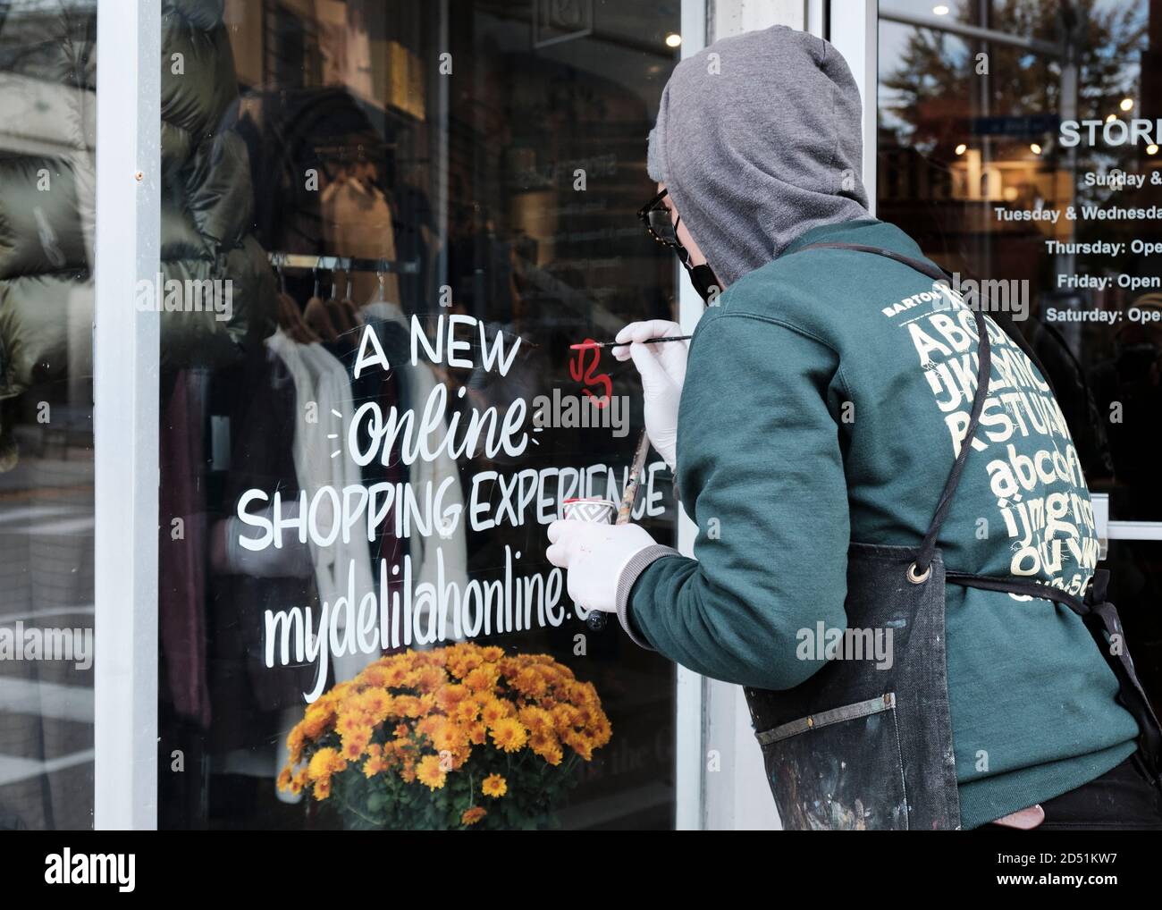 Pascale Arpin, Artist painting old-fashioned hand-lettered window ...