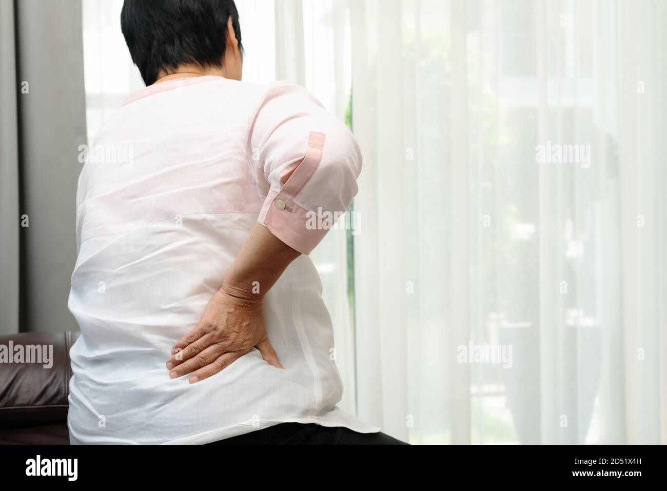 Old woman back pain at home, health problem concept Stock Photo - Alamy