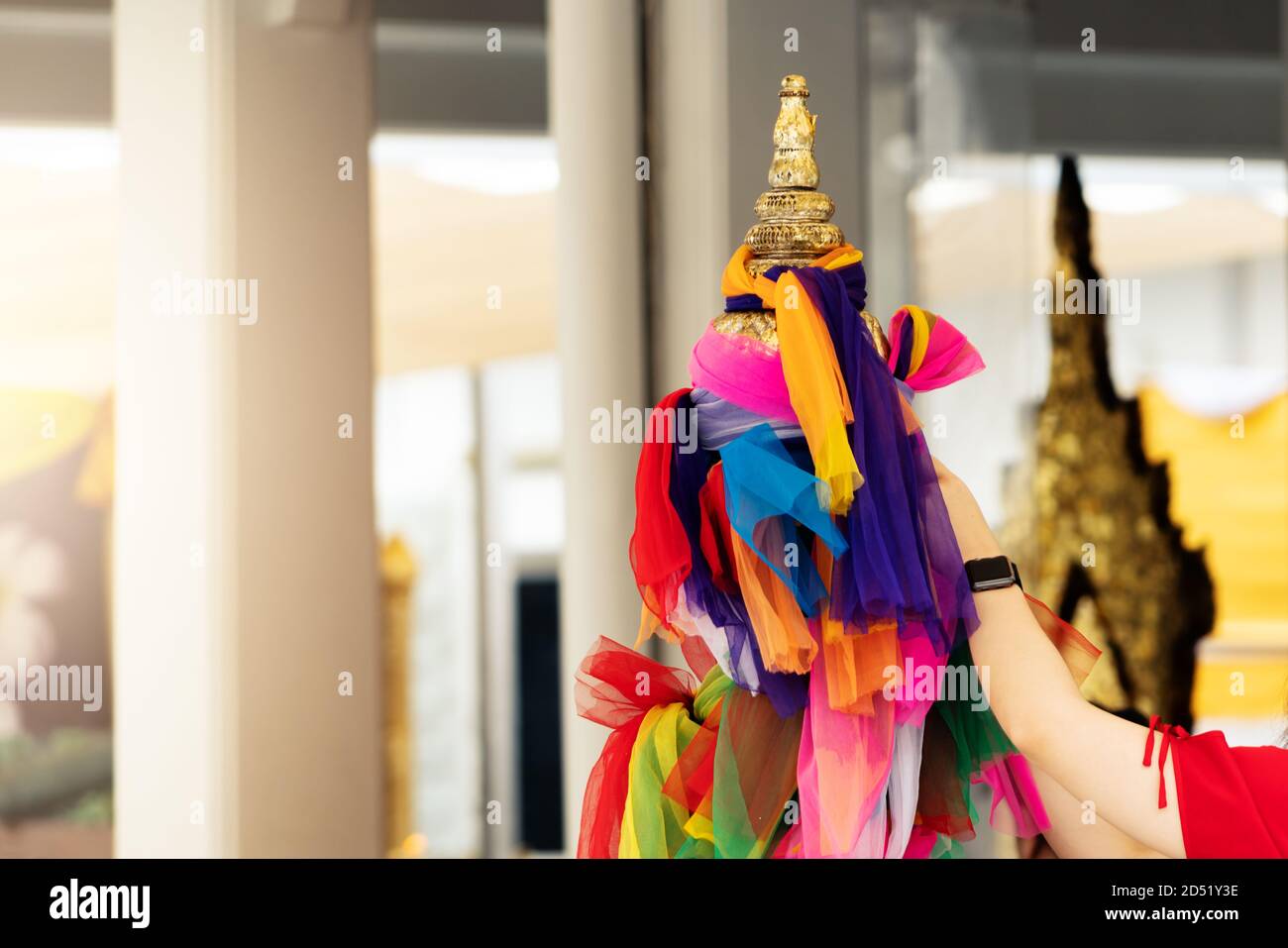 The traditional colorful fabrics tied in the Thai Buddhist Temple for ...
