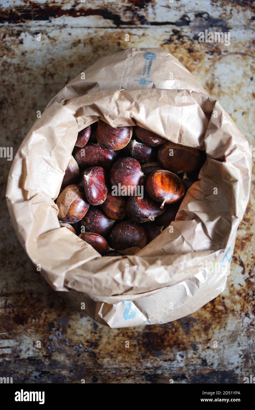 Fresh chestnuts in a paper bag Stock Photo - Alamy