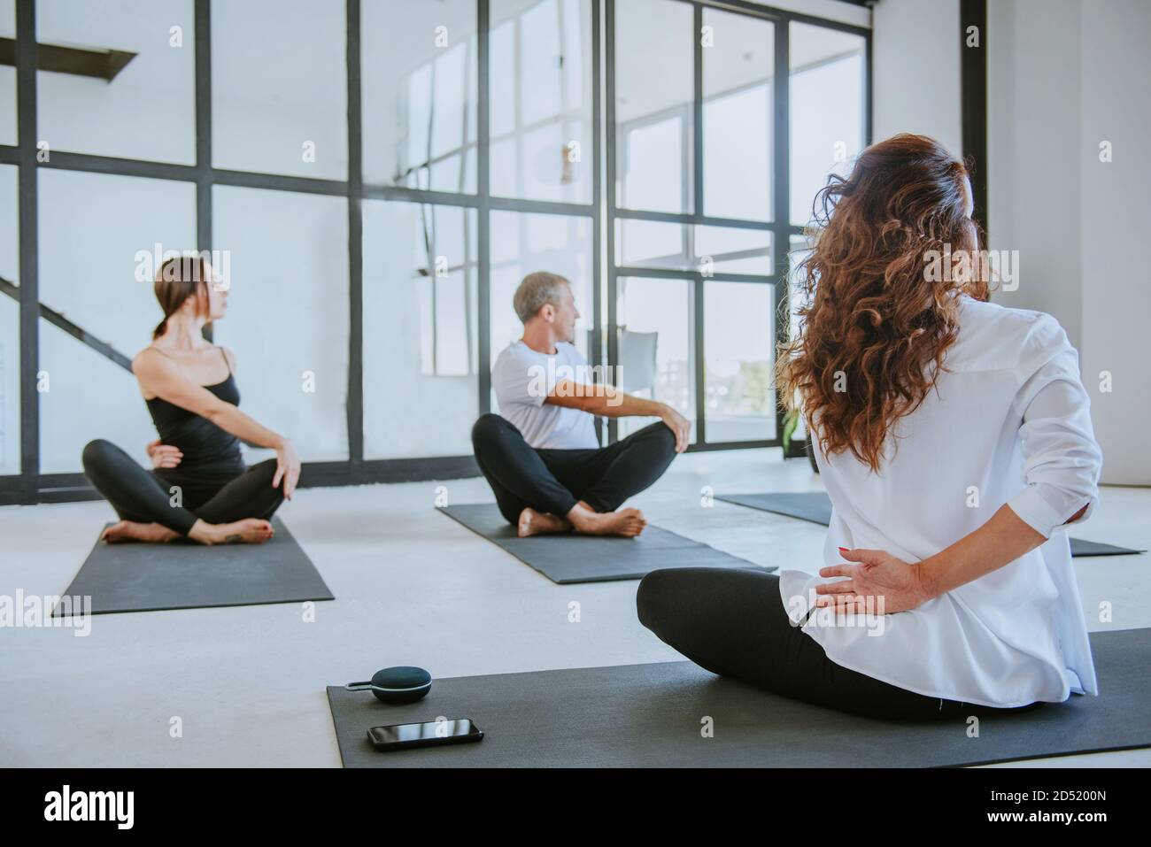 Yoga class of young people group indoor Stock Photo - Alamy