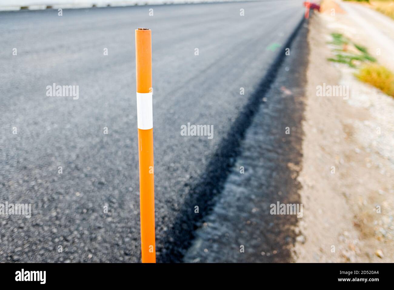 New road construction work, safety poles and asphalt out of focus Stock ...