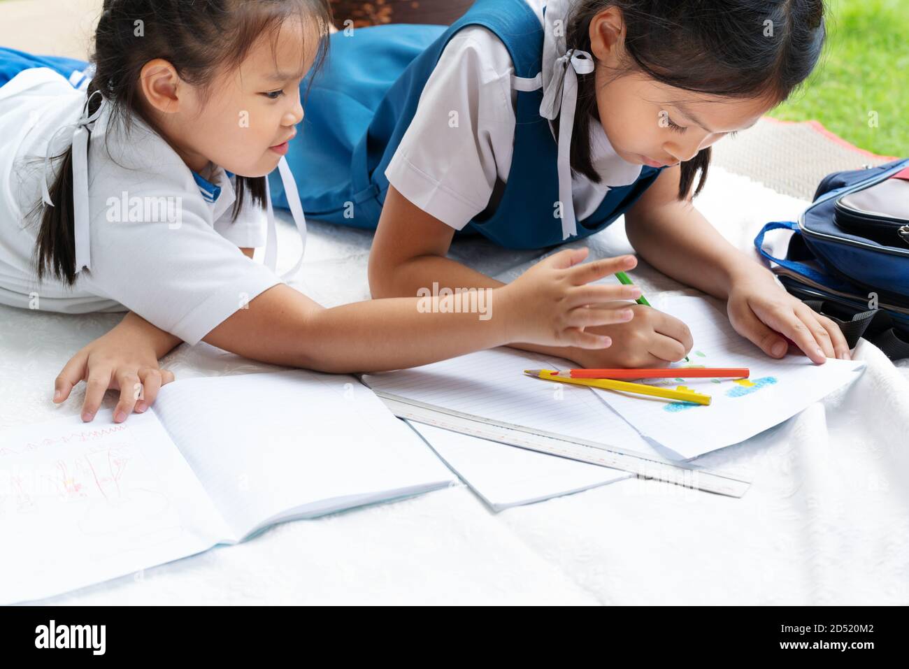 two sister girl writes to writing-books. The decision of lessons. girl ...