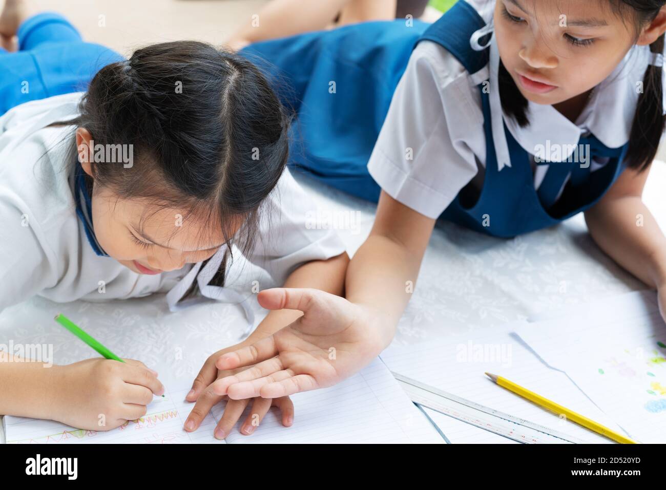 two sister girl writes to writing-books. The decision of lessons. girl ...
