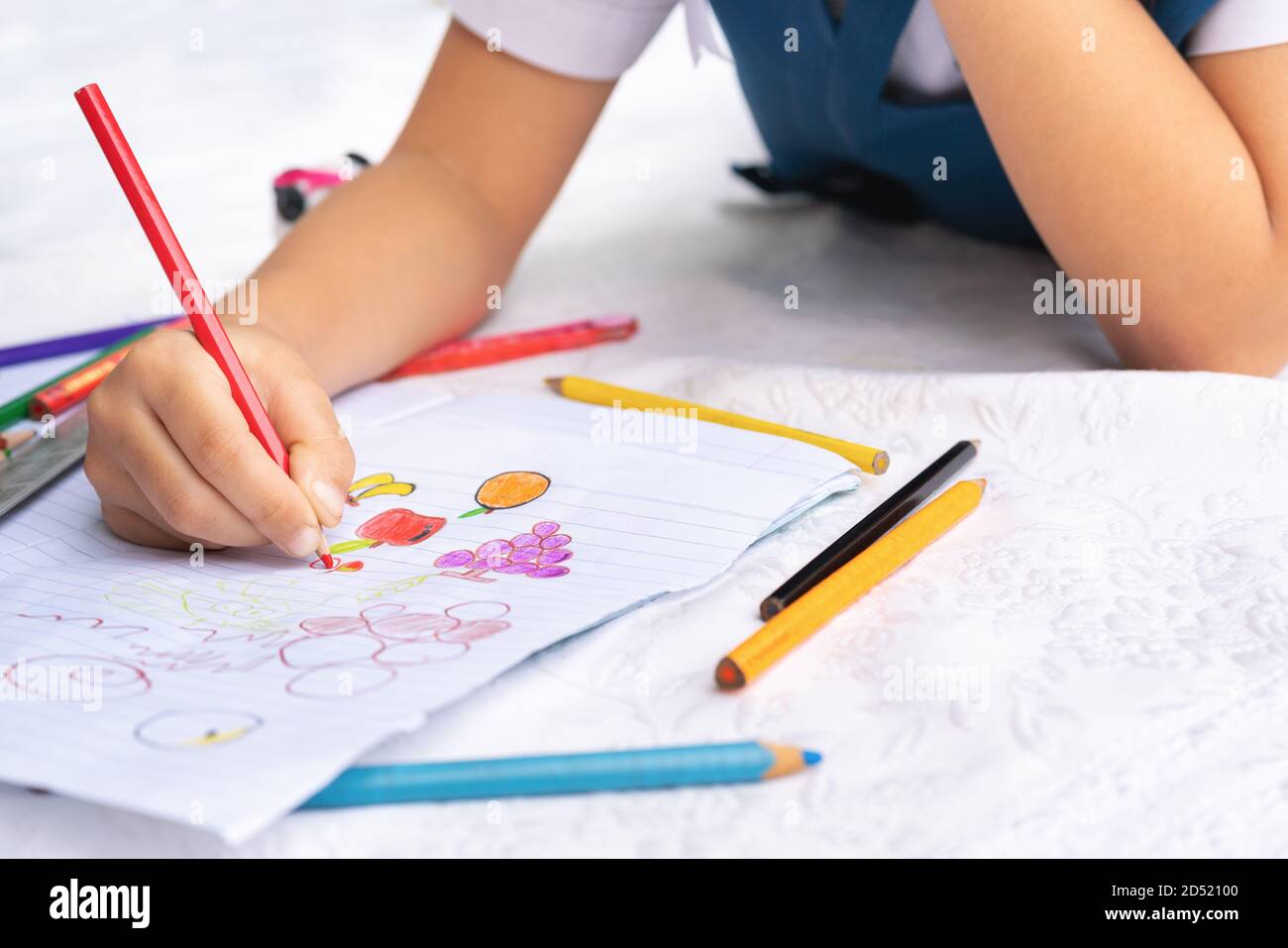 little girl writes to writing-books. The decision of lessons. girl lay ...