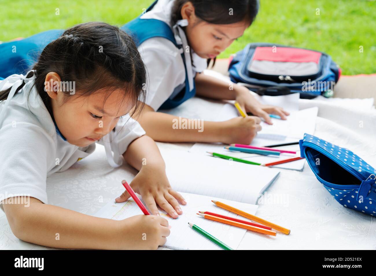 two sister girl writes to writing-books. The decision of lessons. girl ...