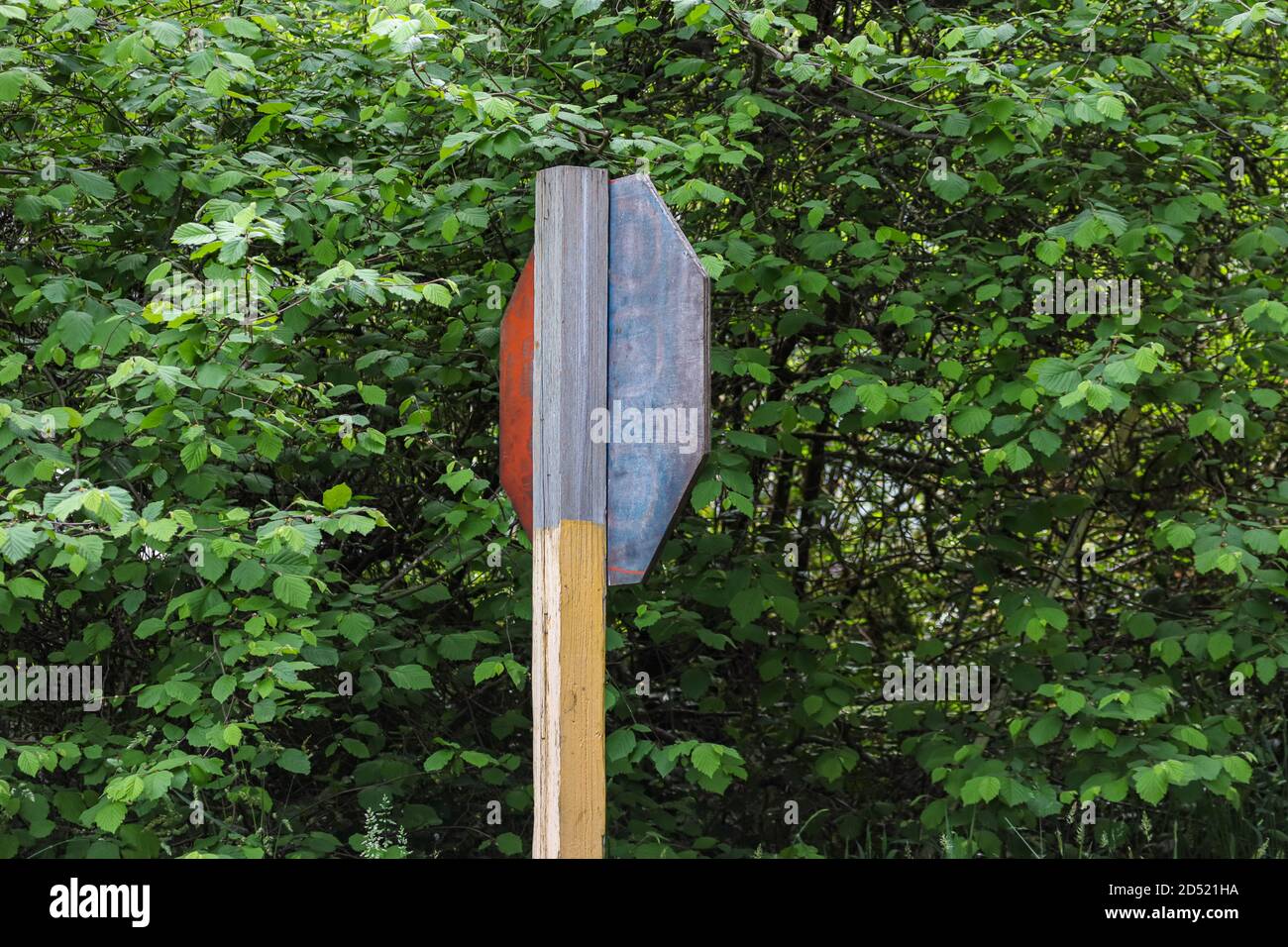 The back of a stop sign in front of bushes Stock Photo - Alamy