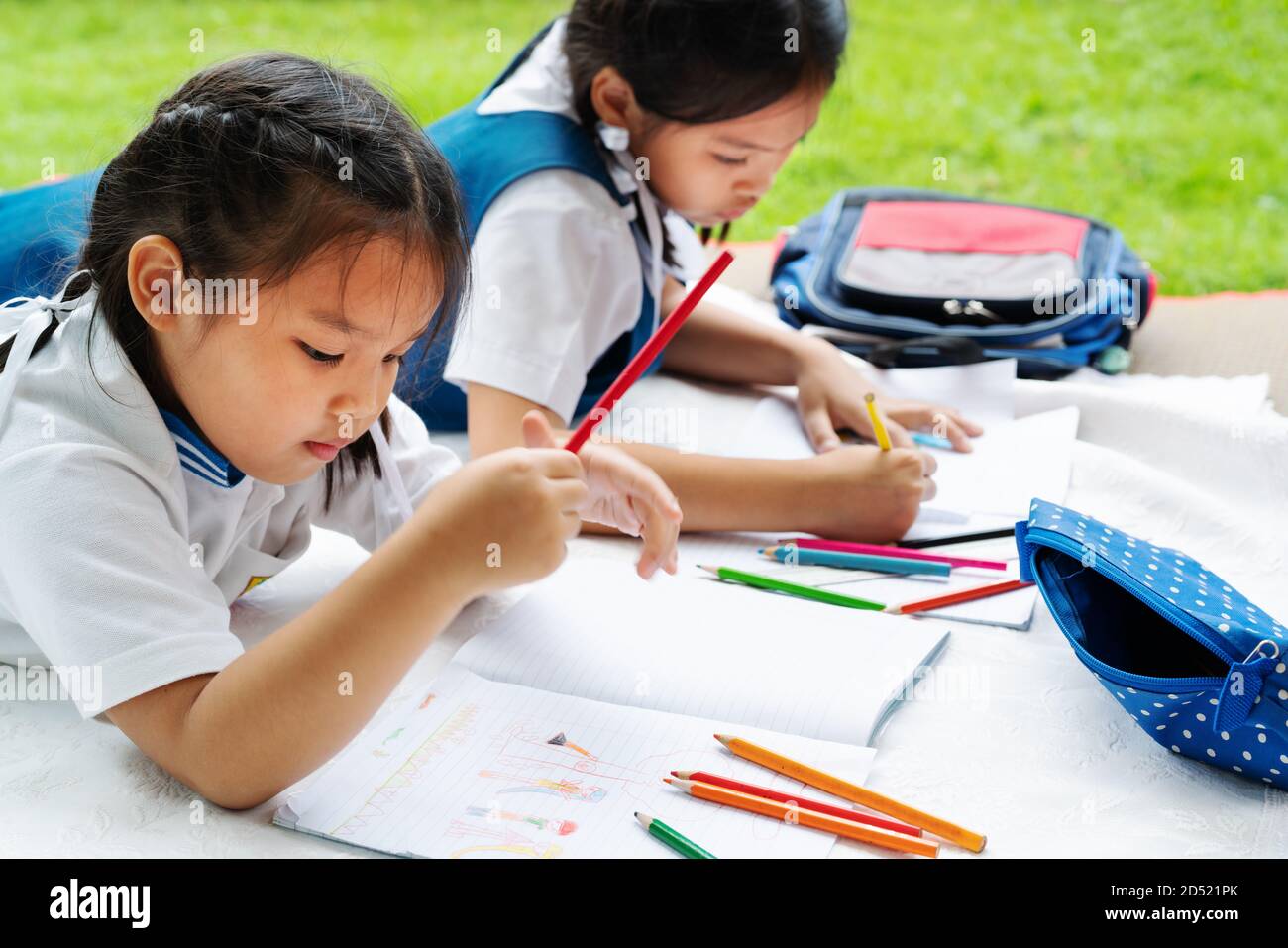 two sister girl writes to writing-books. The decision of lessons. girl ...