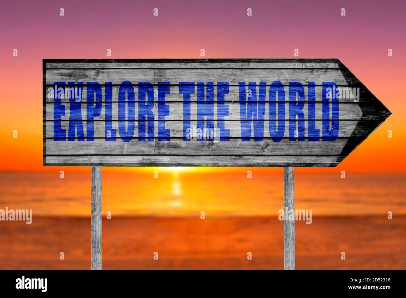Explore the World wooden sign on a beach background Stock Photo - Alamy