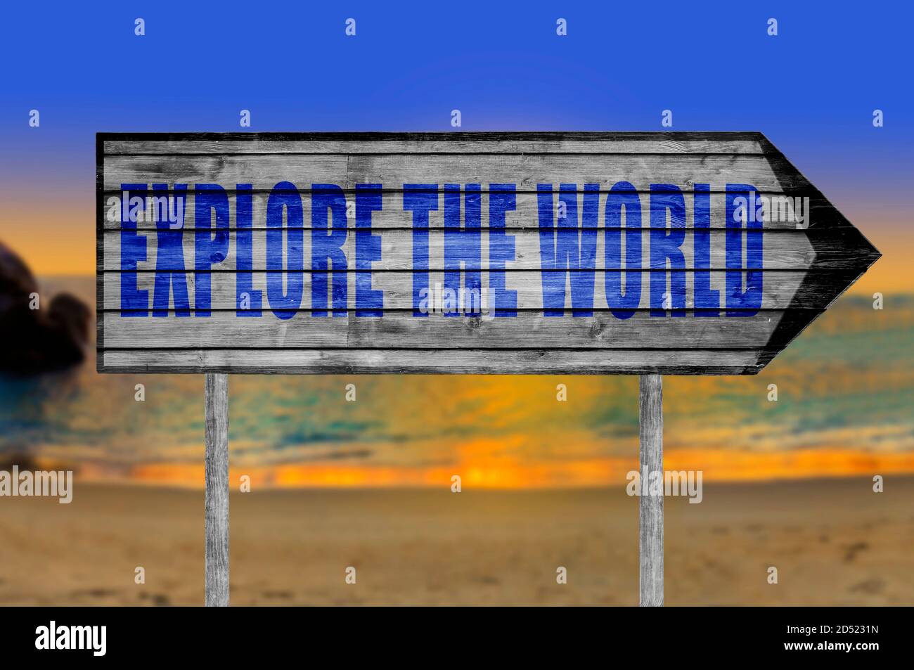 Explore the World wooden sign on a beach background Stock Photo - Alamy