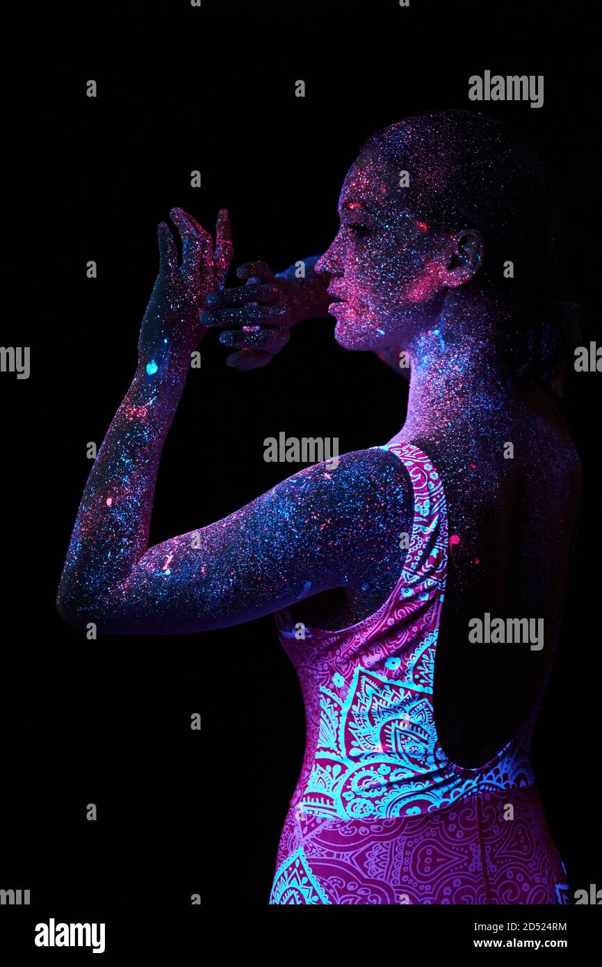 Art woman cosmos in ultraviolet light. Entire body is covered with ...