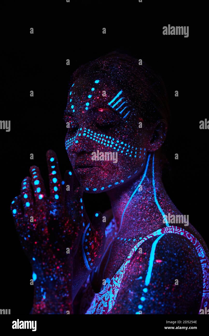 Art woman cosmos in ultraviolet light. Entire body is covered with ...