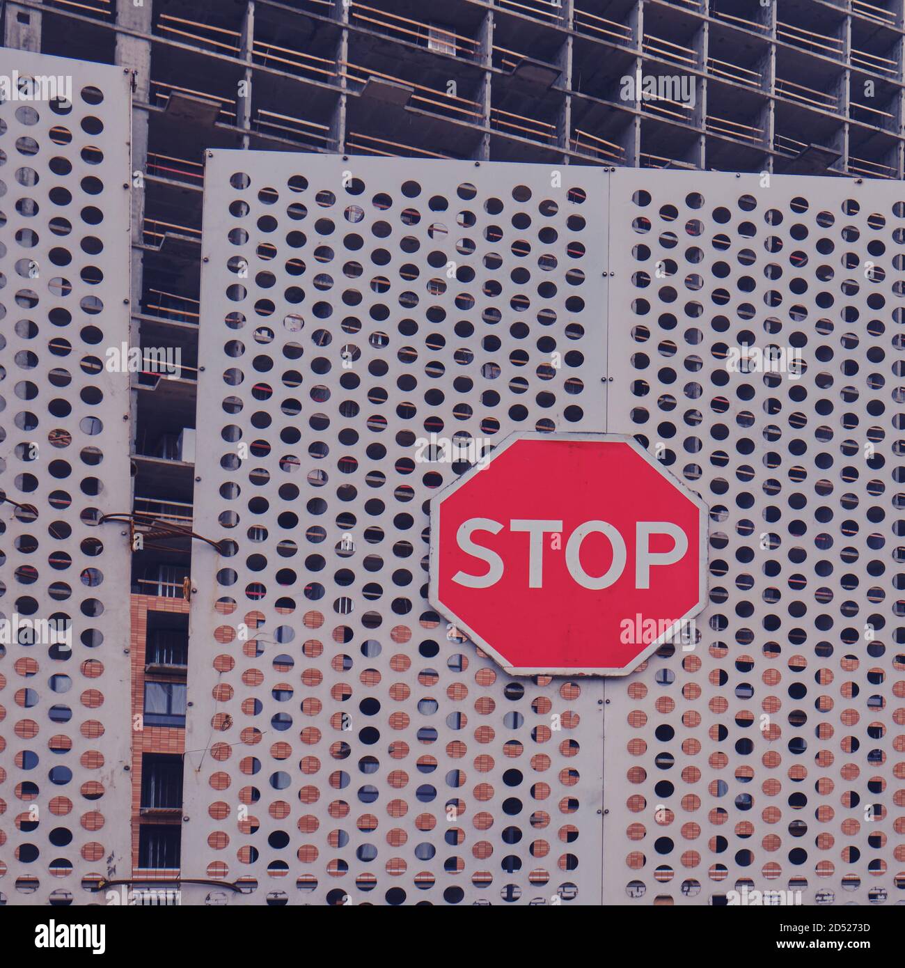 A gate with a stop sign at the entrance to the construction site ...