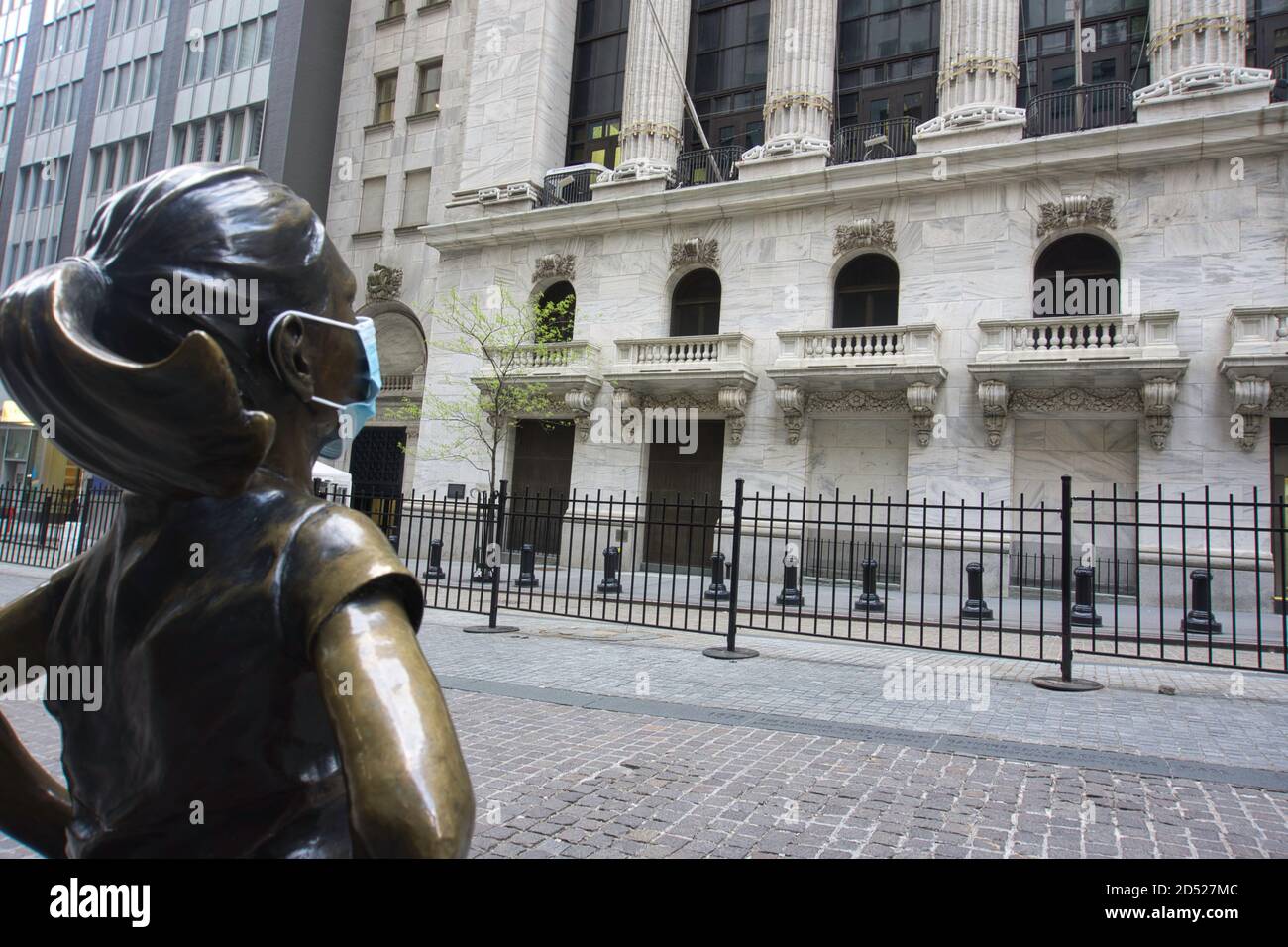 The bronze statue entitled "Fearless Girl" wearing surgical mask during ...