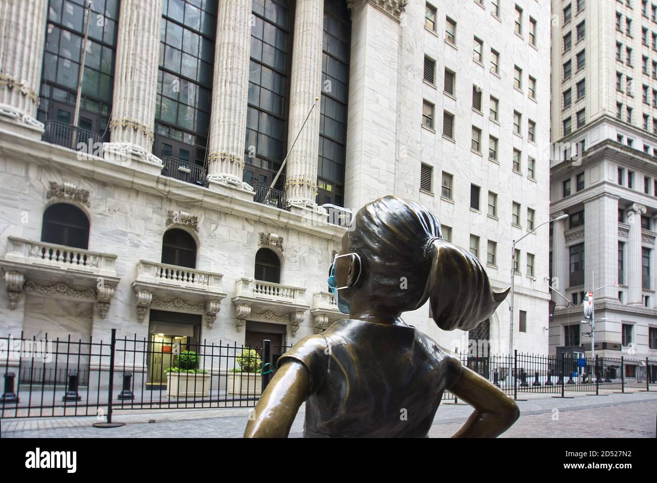 The bronze statue entitled "Fearless Girl" wearing surgical mask during ...