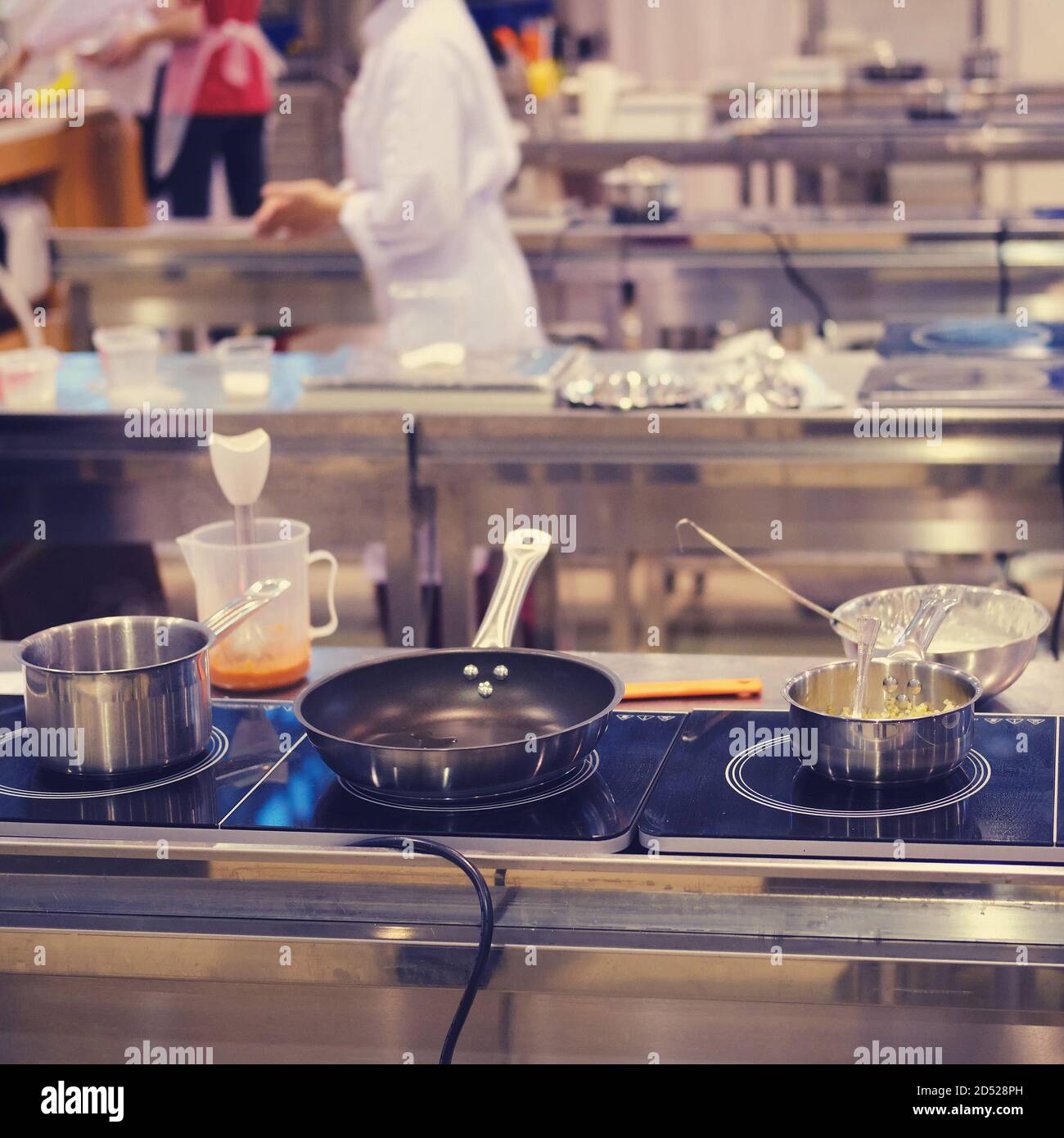 Cooking in the kitchen of restaurants and cafes using electric stoves ...