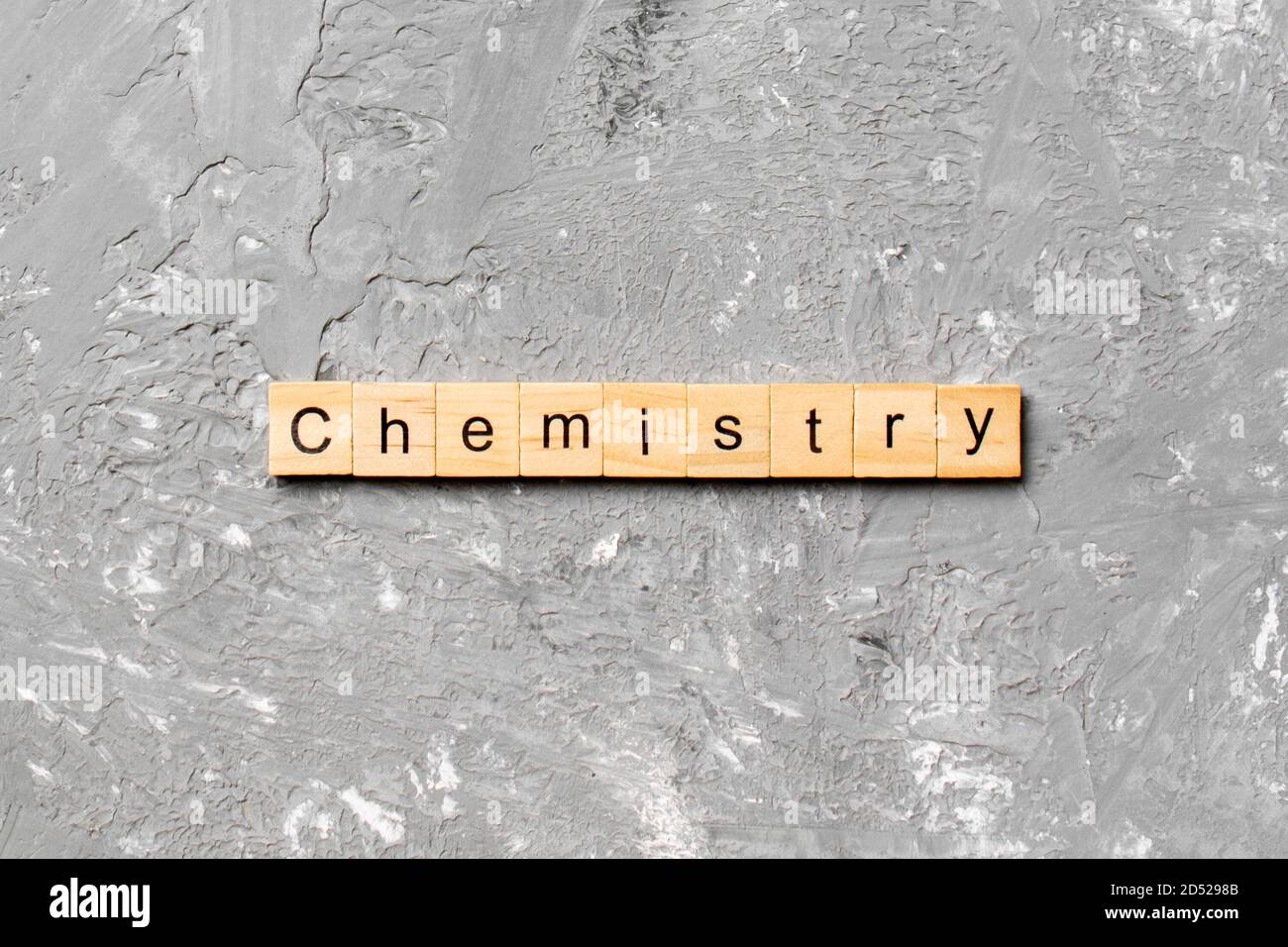 Chemistry word written on wood block. Chemistry text on cement table ...