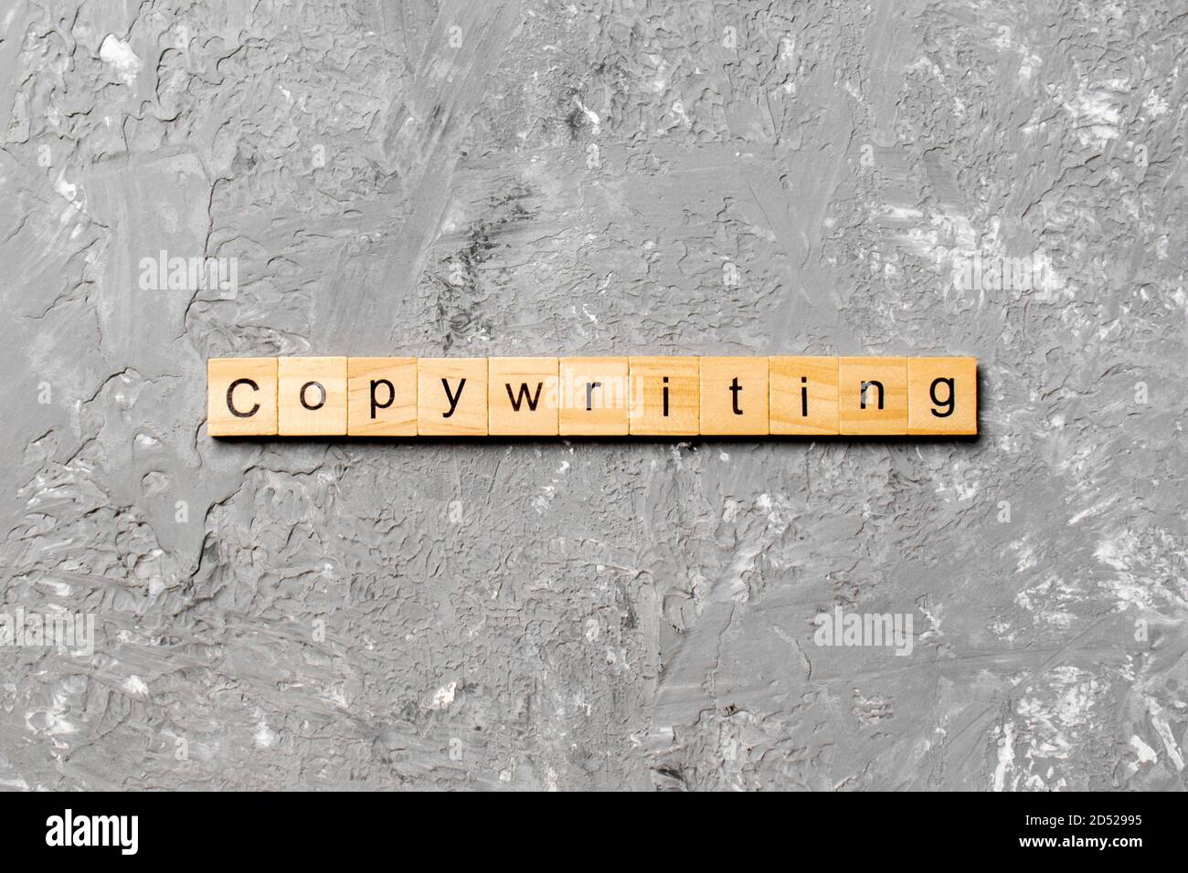 Copywriting word written on wood block. Copywriting text on cement ...