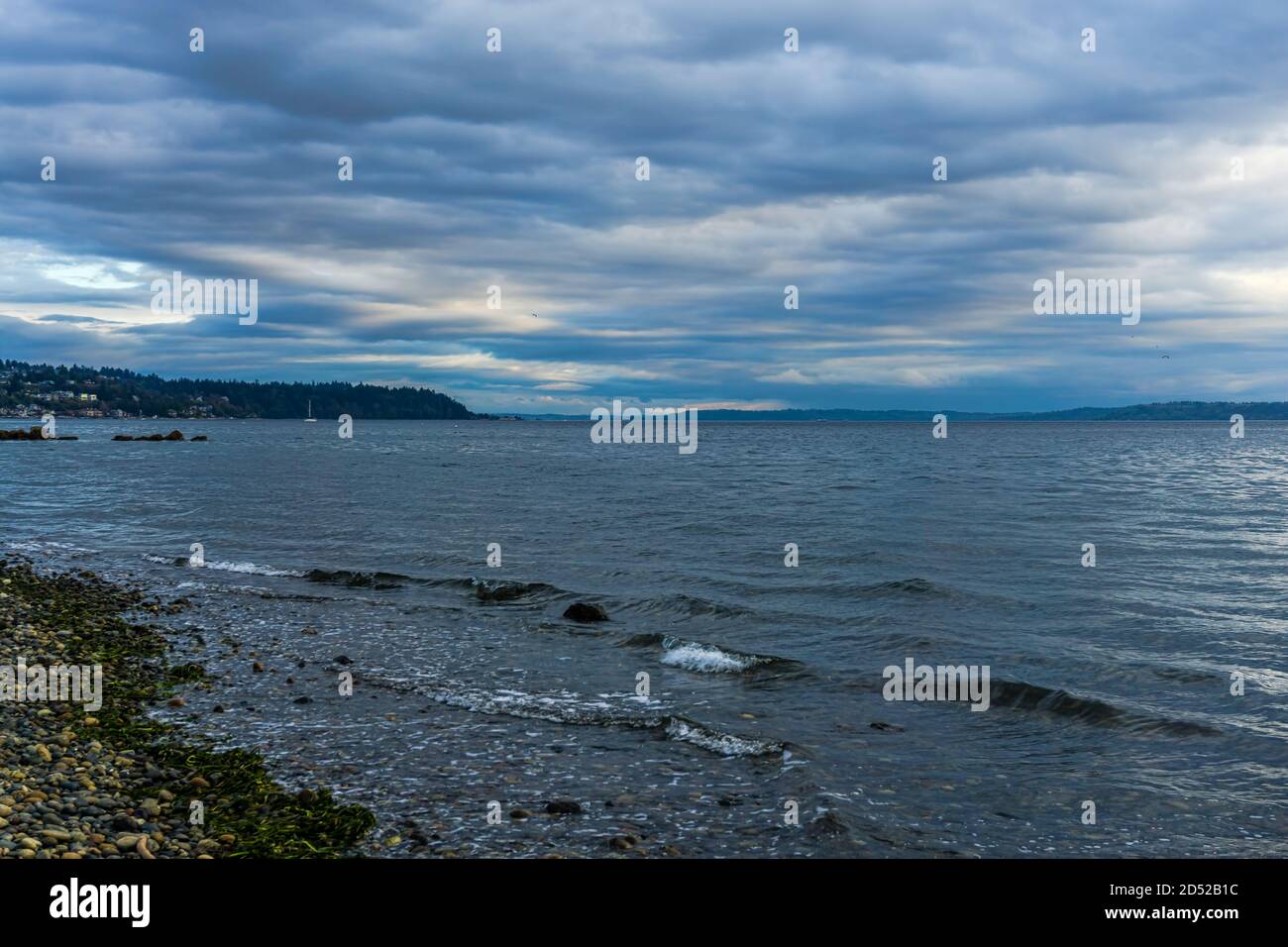 Dark clouds hang over the Puget Sound at sunset. Photo taken in West ...