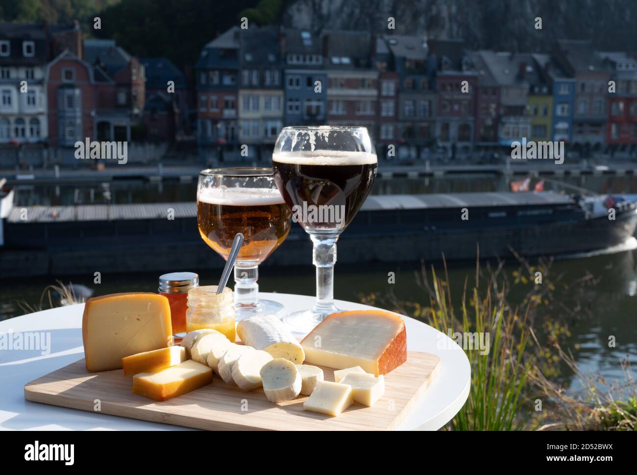 Glass of strong Belgian abbey beer and tasting of cheeses made with ...