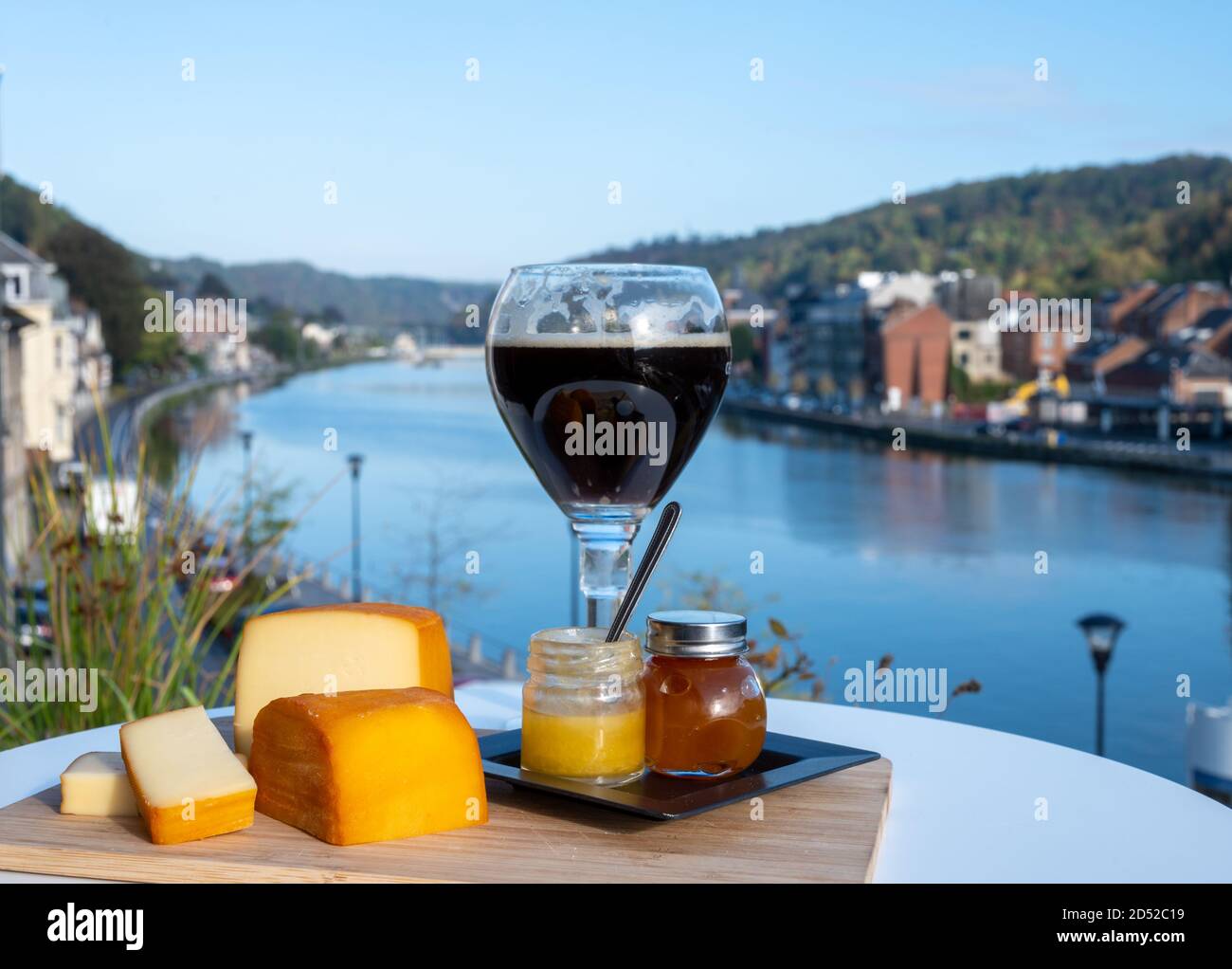 Glass of strong Belgian abbey beer and tasting of cheeses made with ...