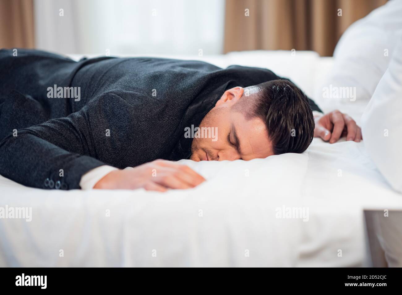 Exhausted Businessman Asleep In Hotel Bed room Stock Photo - Alamy