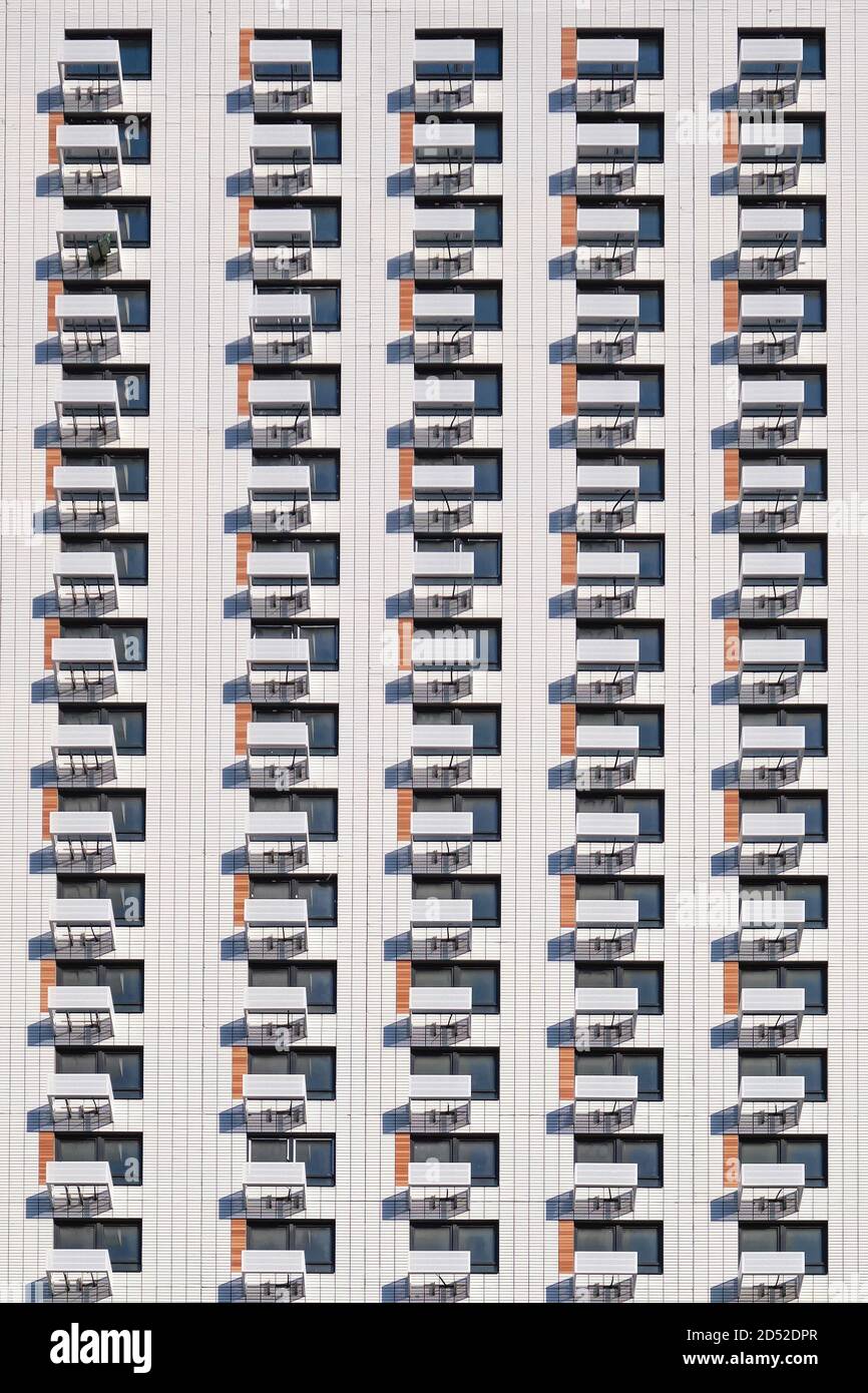 Windows of a white building in regular rows. Unusual bottom view of the ...