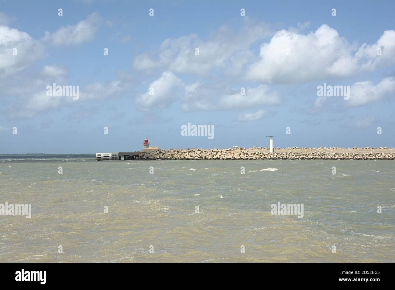 Pier with radar tower and lighthouse in the north sea in the harbor of ...