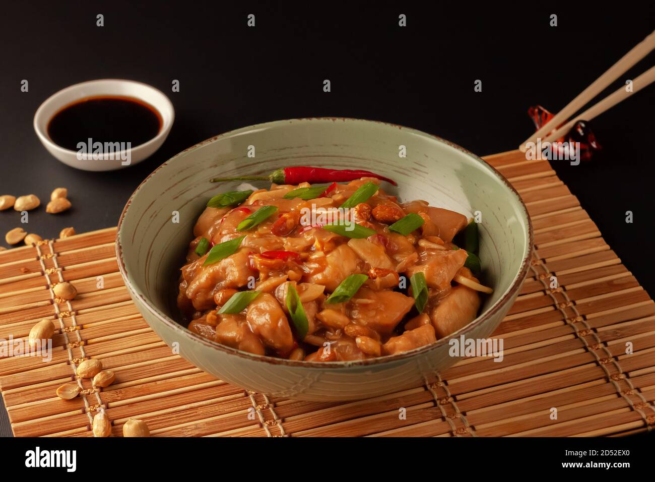 Kung Bao chicken on a black background. A Chinese dish with chicken ...