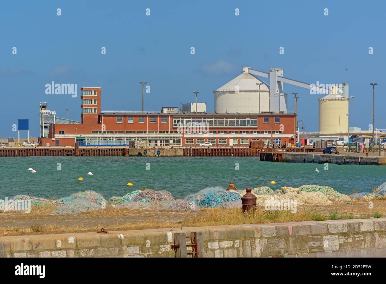 Quay along a dock with silo`s and cranes in in the harbor of Calais ...