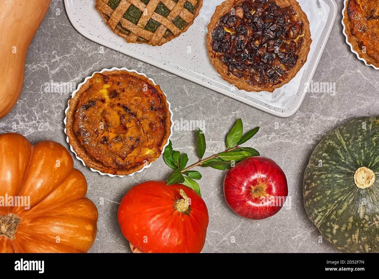 Cozy autumn food background. Top view of pumpkins, apples and small ...