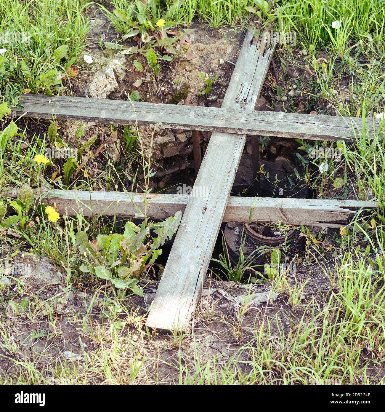 Dangerous well closed with old boards. Violation of safety regulations ...
