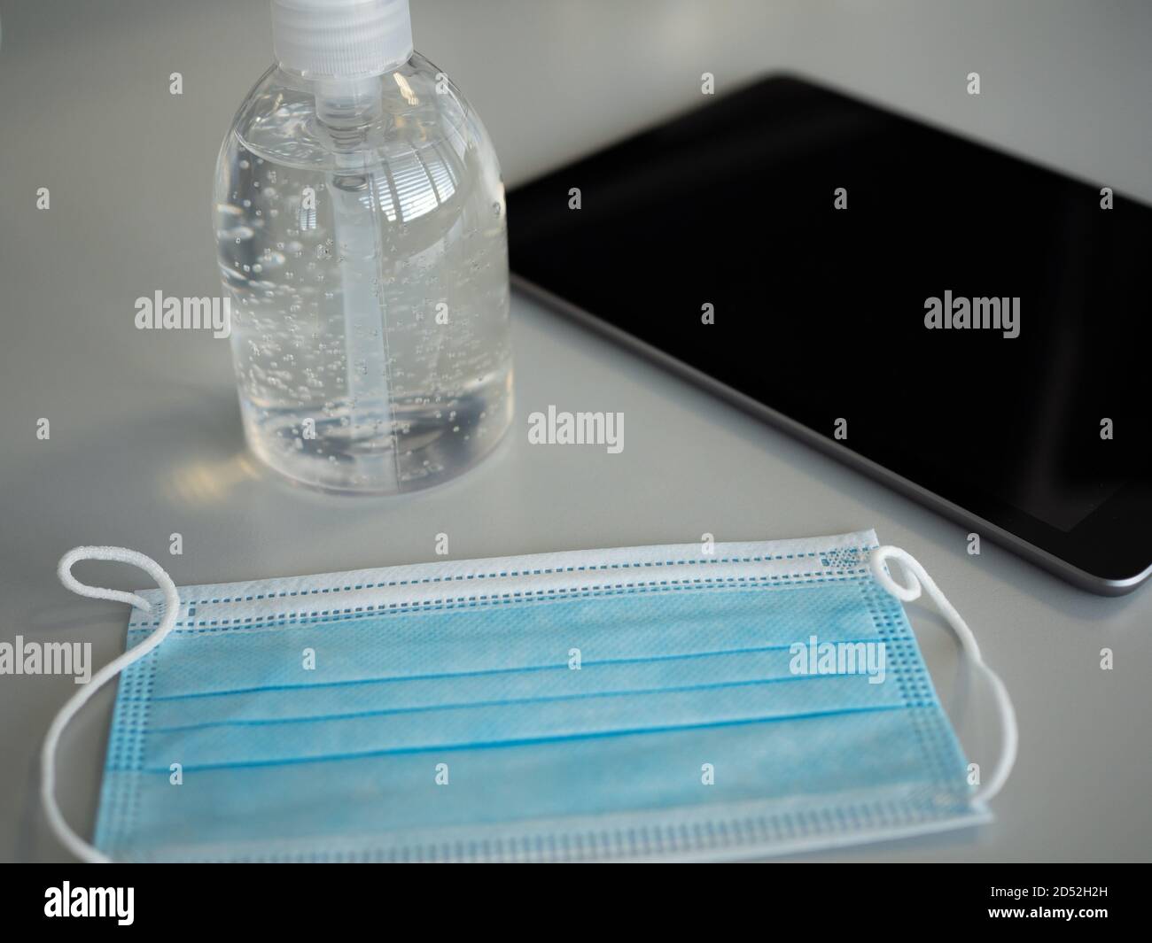 Hydroalcoholic gel for hand disinfection with mask in the office Stock ...