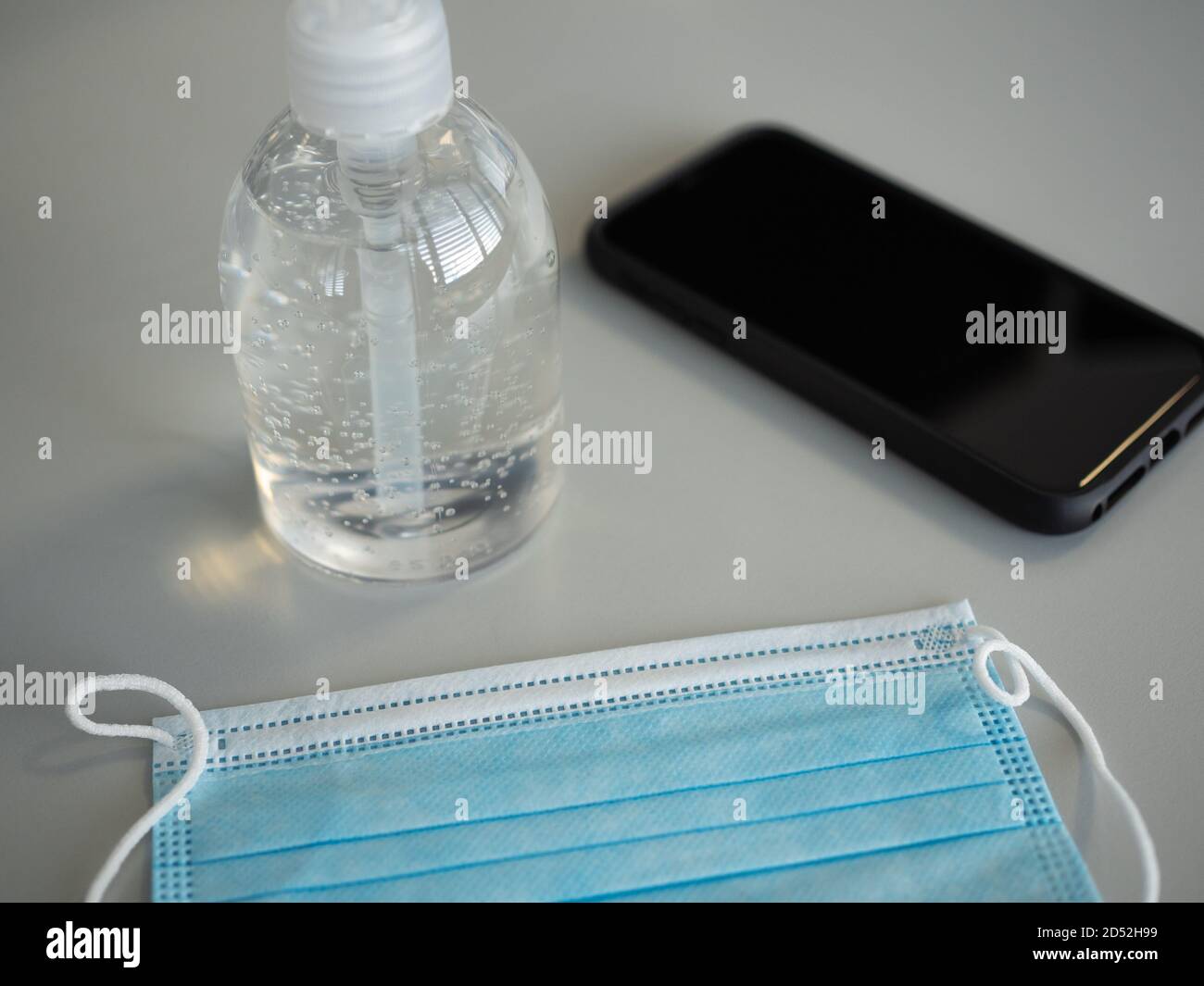 Hydroalcoholic gel for hand disinfection with mask in the office Stock ...