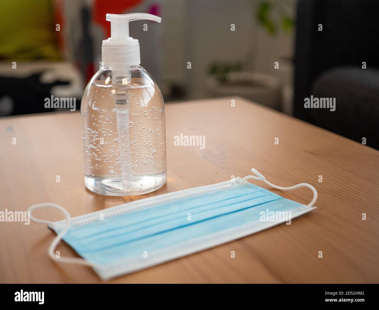 Hydroalcoholic gel for hand disinfection with mask in the office Stock ...