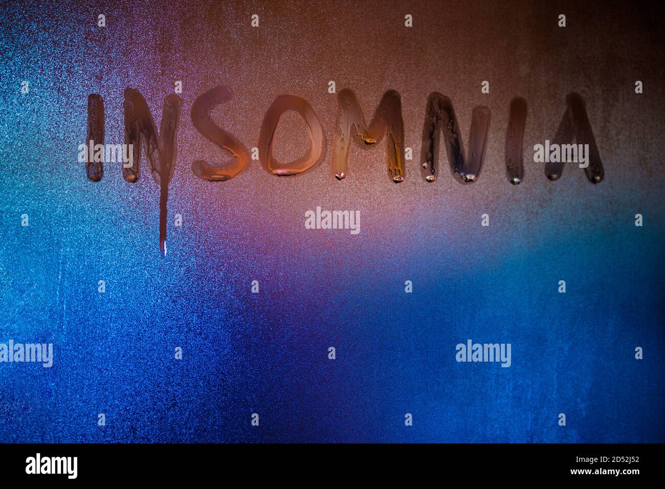 The Word Insomnia Handwritten By Finger On Night Wet Window Glass Close