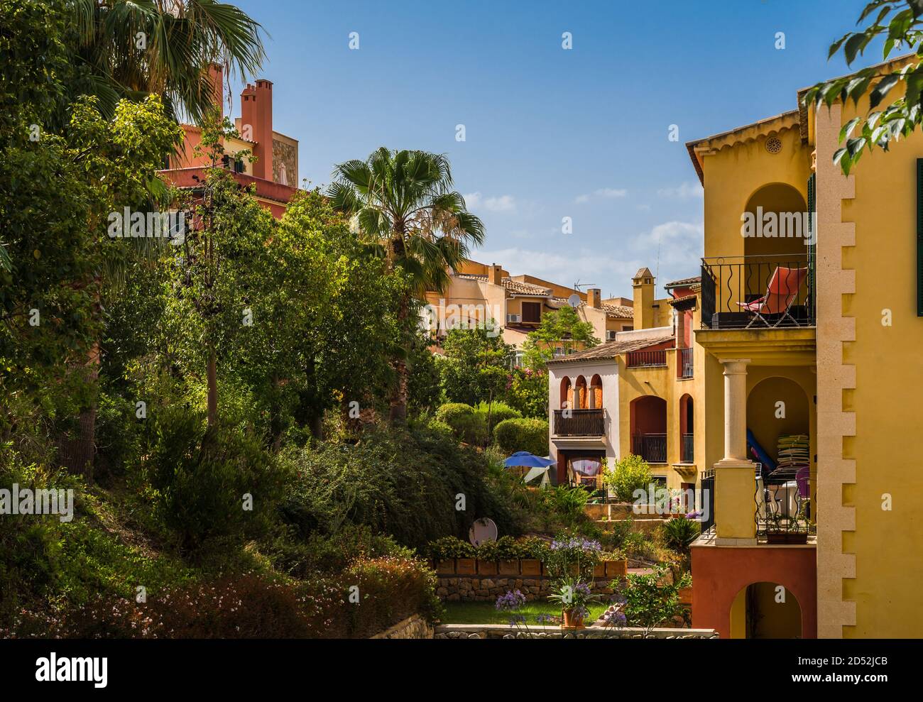 Beautiful small colorful buildings and palm trees in Majorca, Spain ...
