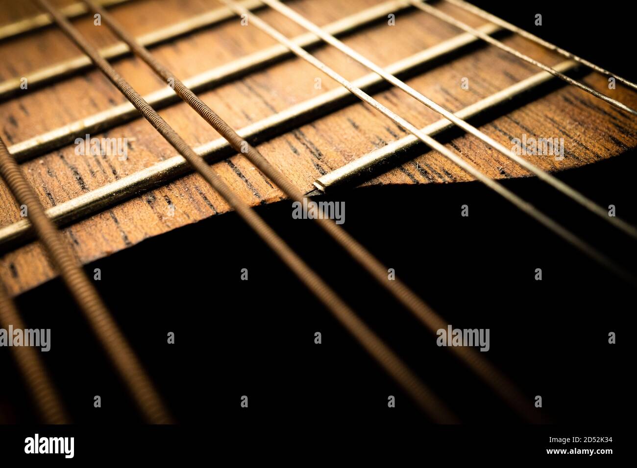 Macro Photo of curved end of mandolin fretboard in darkness and no body ...