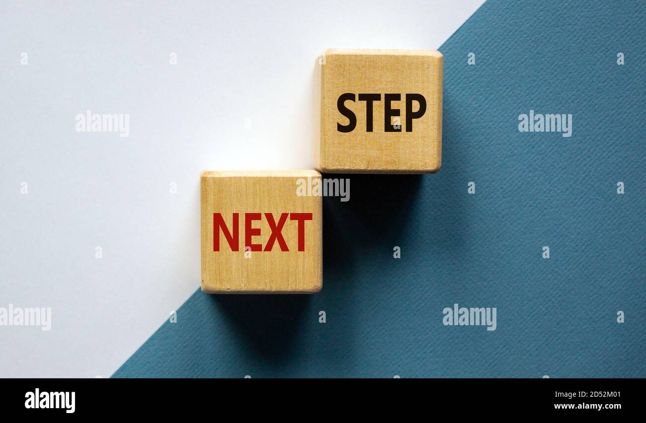 Conceptual image of motivation. Wooden cubes with words 'next step ...