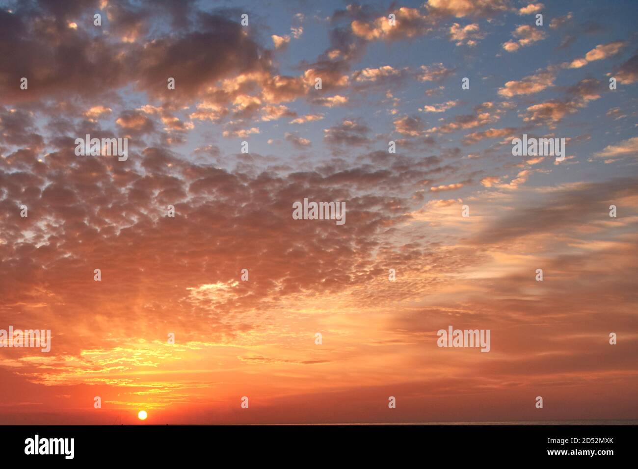 Sunset. Heaven, orange sky. Sun rays. Wallpaper. Clouds Stock Photo - Alamy