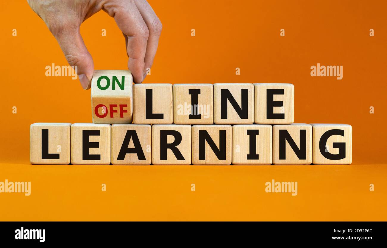Time to online learning. Male hand turns the cube and changes the ...