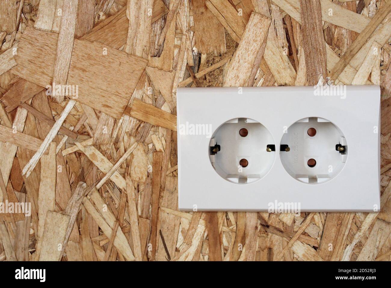 New white double power socket on the wooden wall with copy space for ...