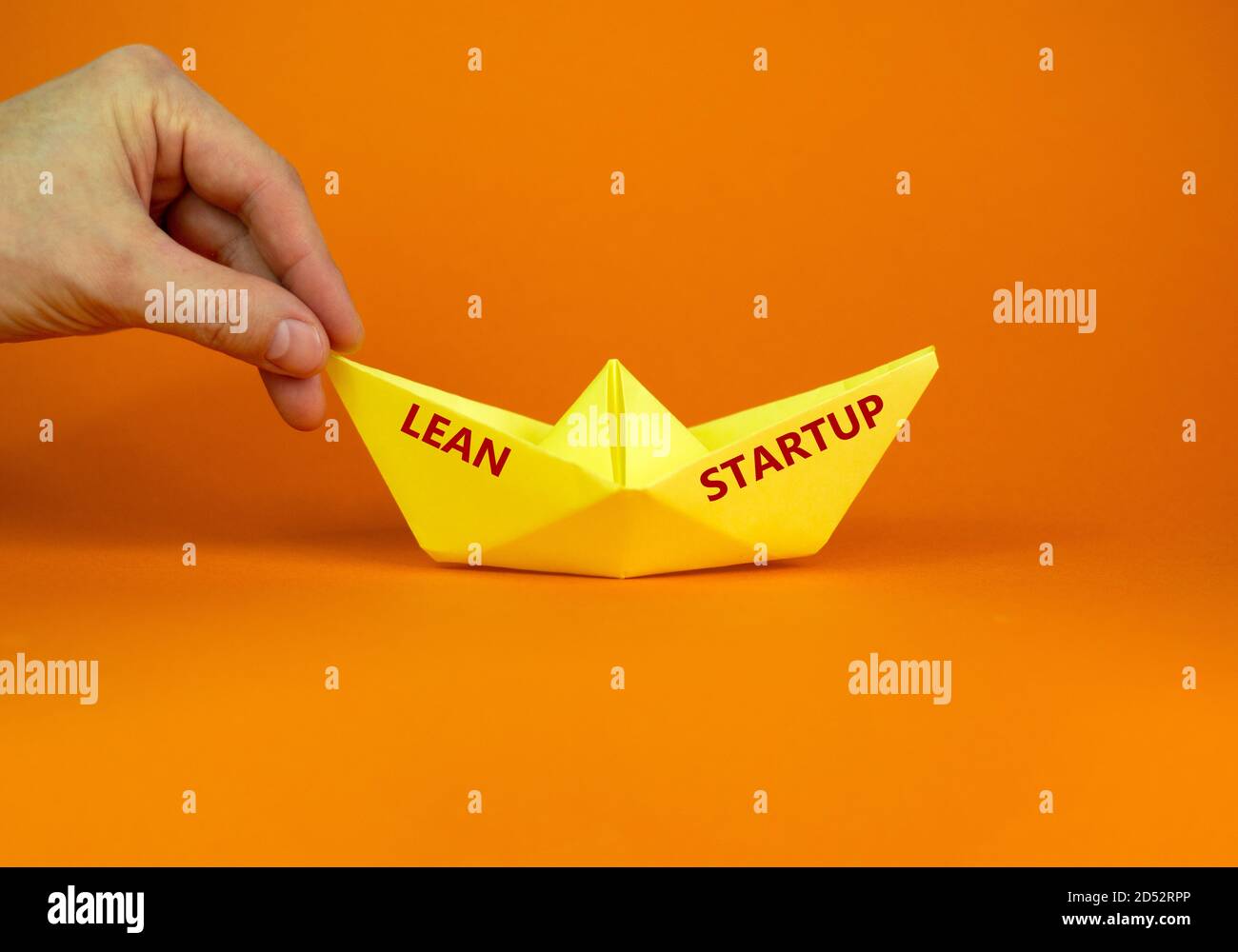 Image of businessman pushing paper made origami boat forward in a ...