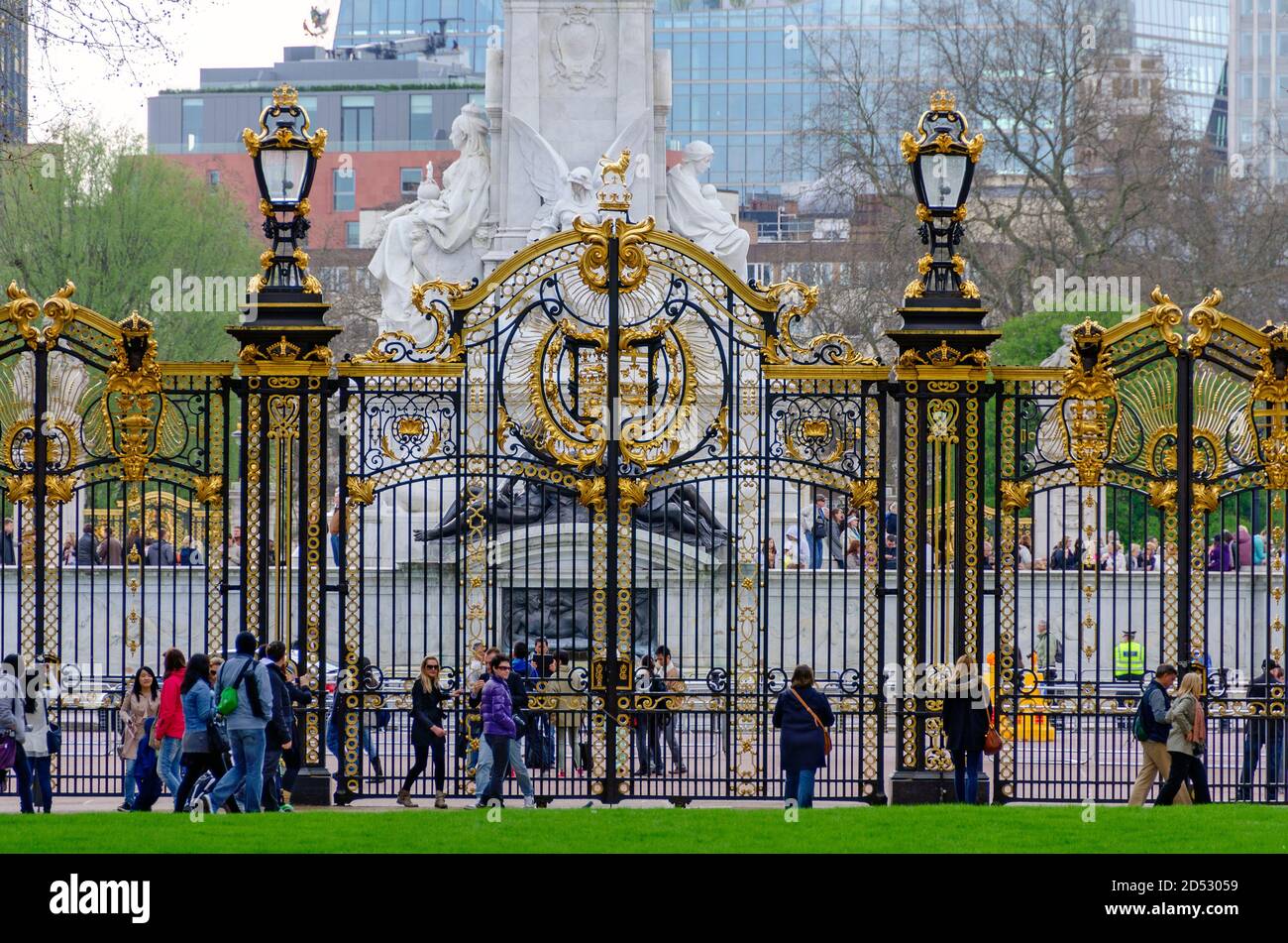 tourist at the golden and black colored iron Canada gate and victoria ...