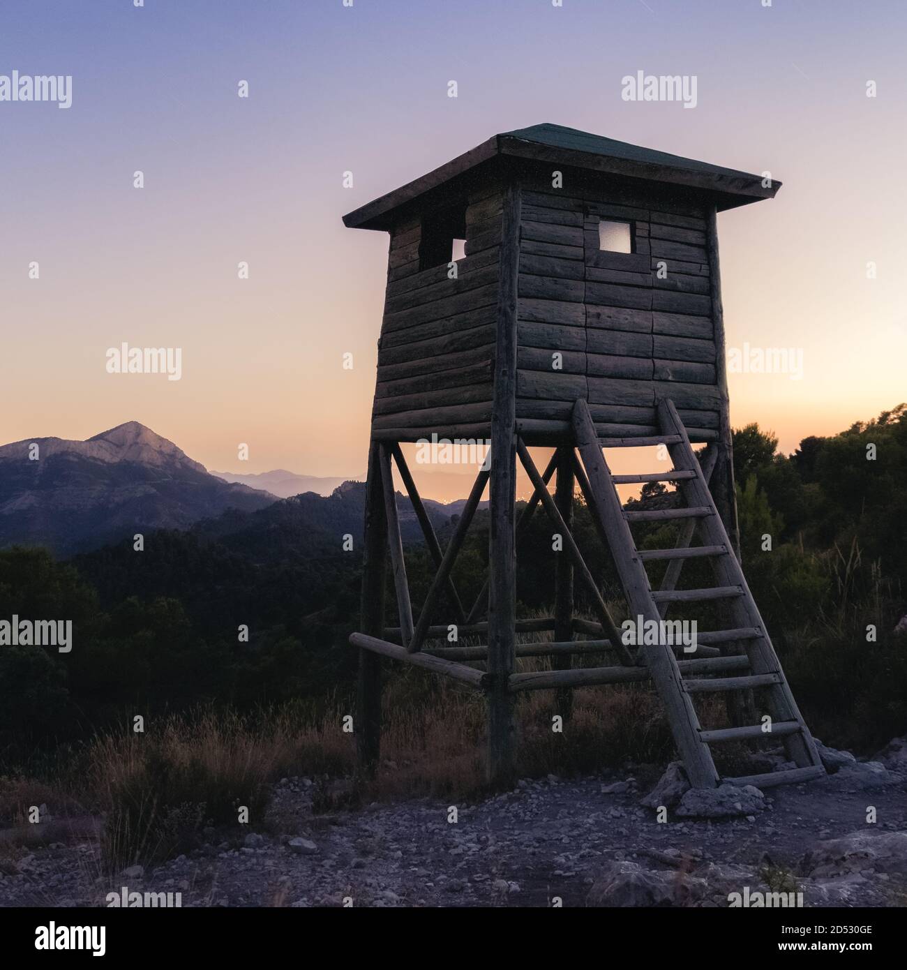 Wooden observation tower in a forest in Cati Alicante, Spain at sunset ...