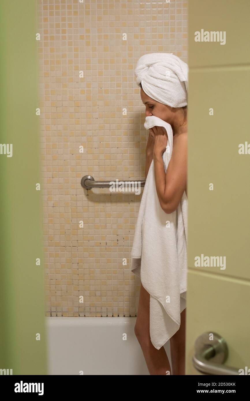 Woman in bath robe opening door hi-res stock photography and images - Alamy