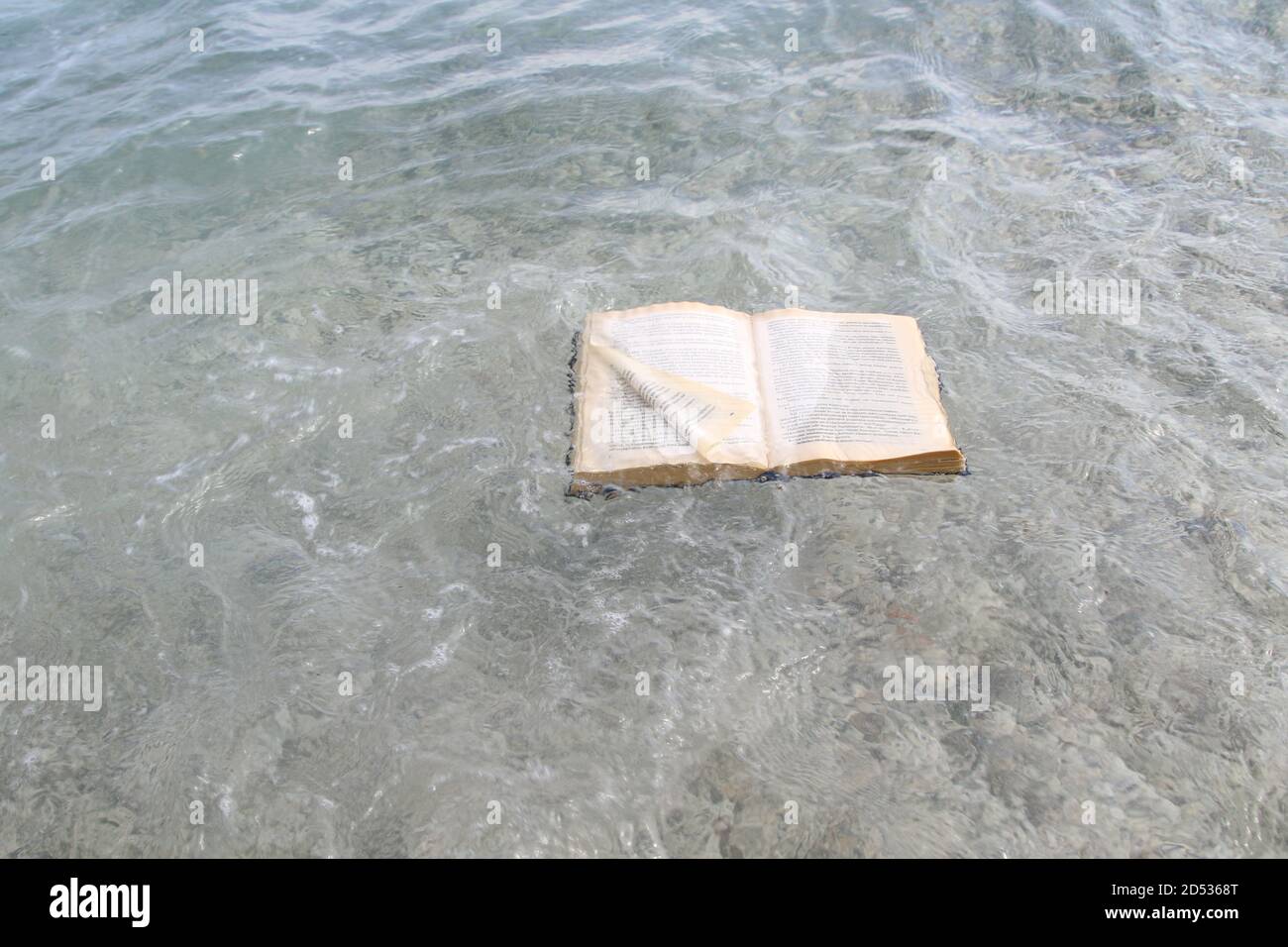 open book floating on water Stock Photo - Alamy