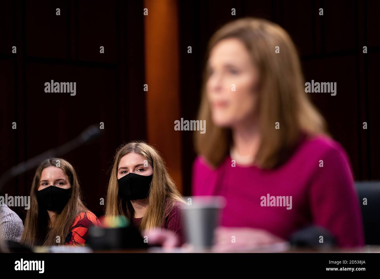 Two of Judge Amy Coney Barrett's daughters watch her speak during the ...